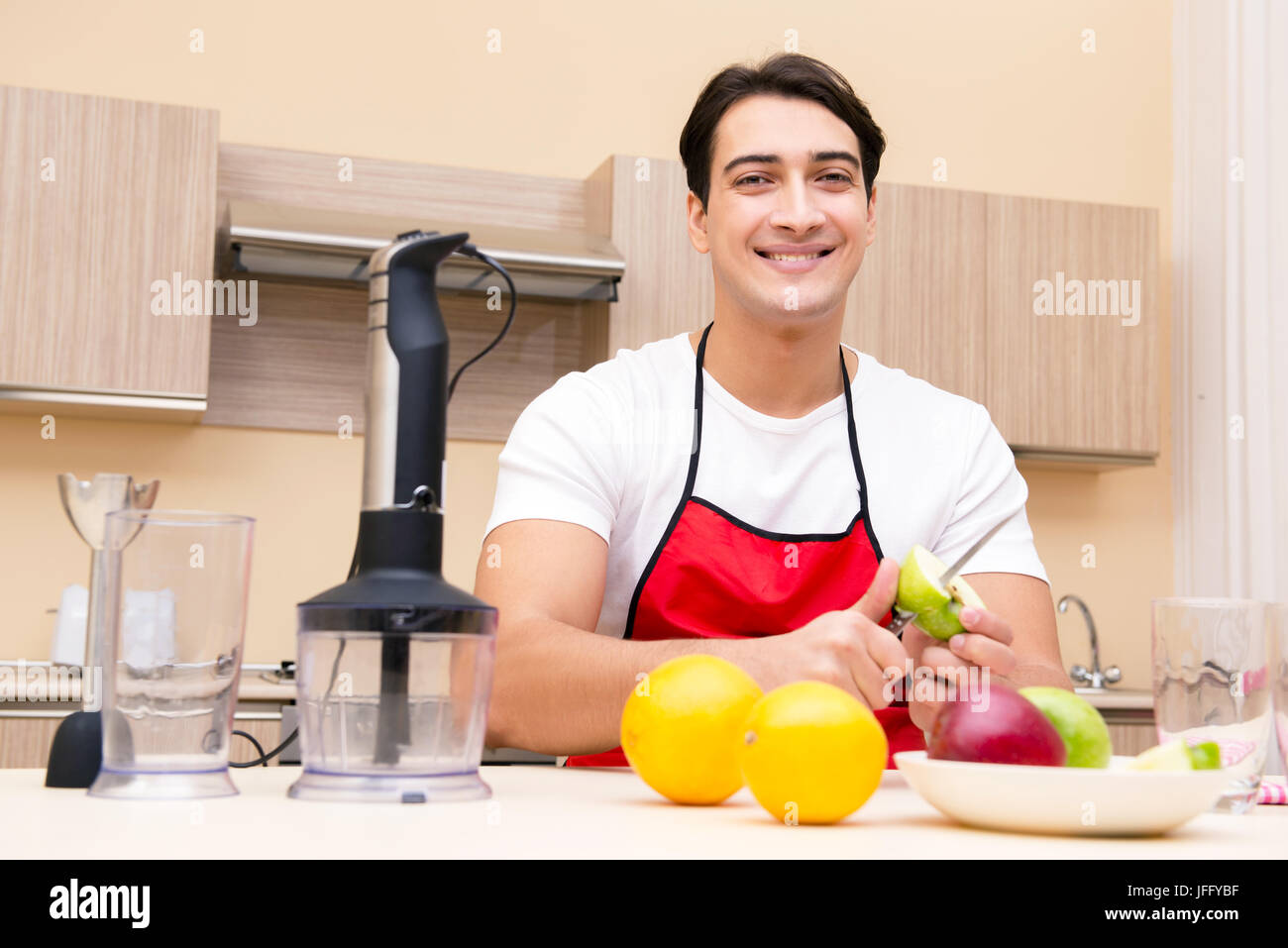 Handsome man working at the kitchen Stock Photo - Alamy