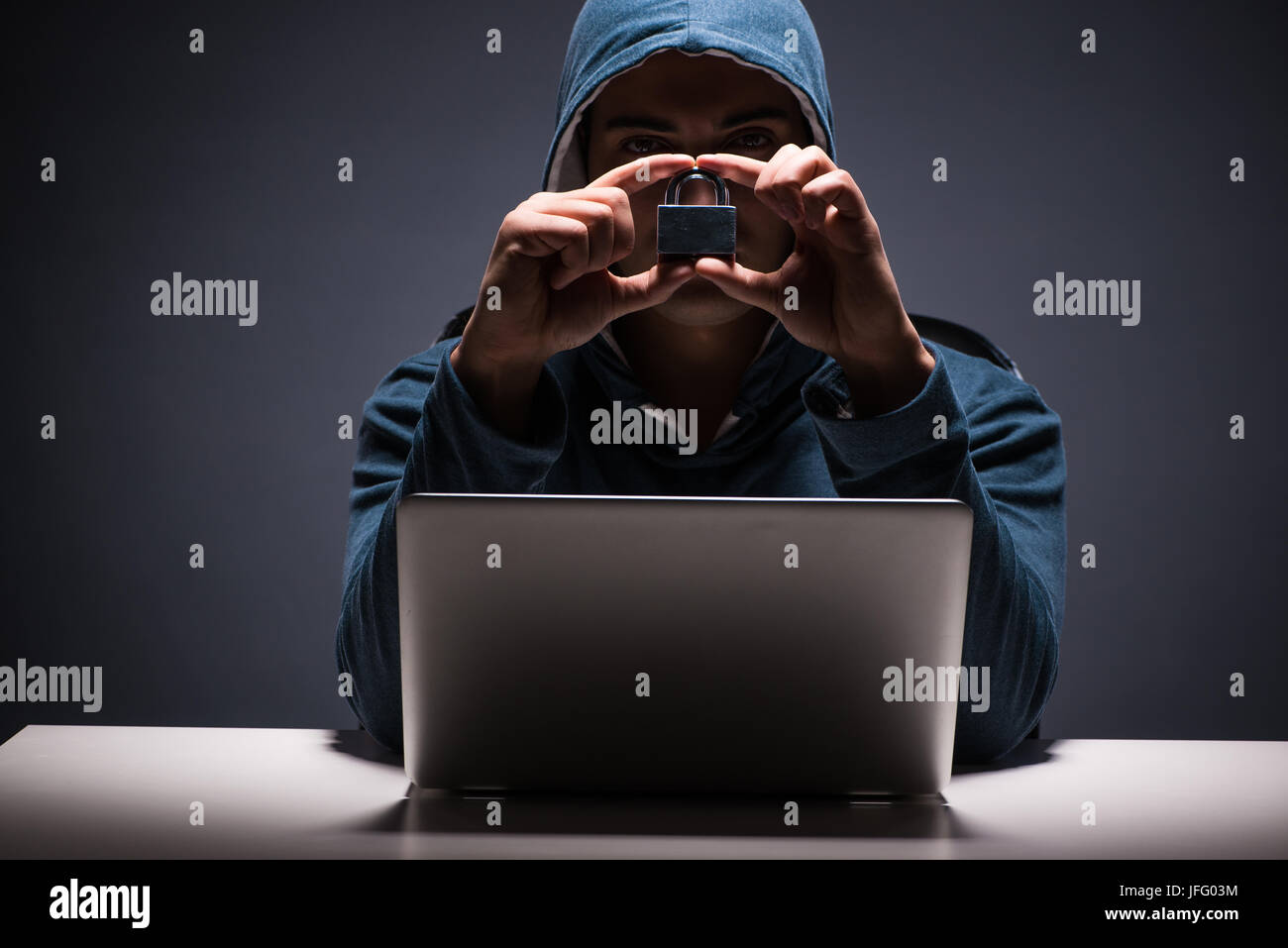 Computer hacker working in dark room Stock Photo - Alamy