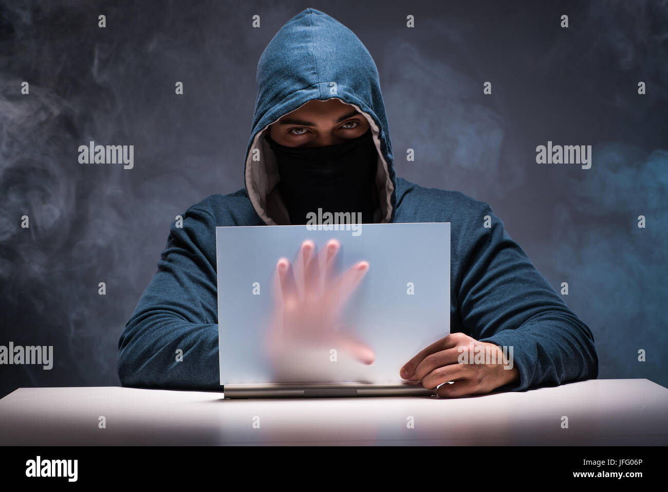 Computer hacker working in dark room Stock Photo - Alamy