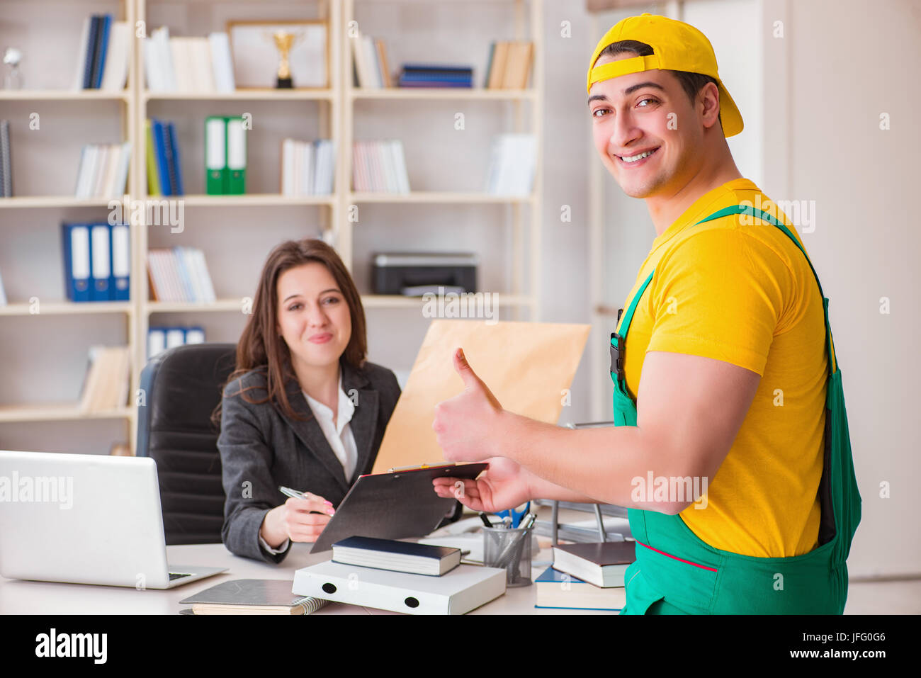 Postman delivering parcel to the office Stock Photo - Alamy
