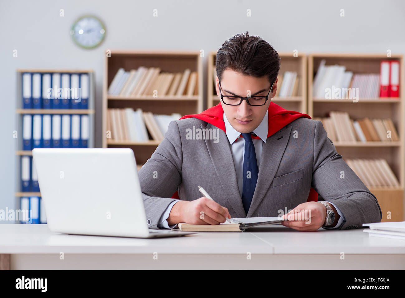 Superhero businessman working in the office Stock Photo - Alamy