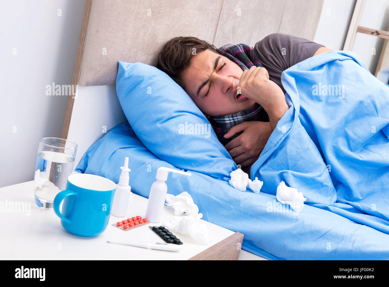 Sick man with flu lying in the bed Stock Photo - Alamy