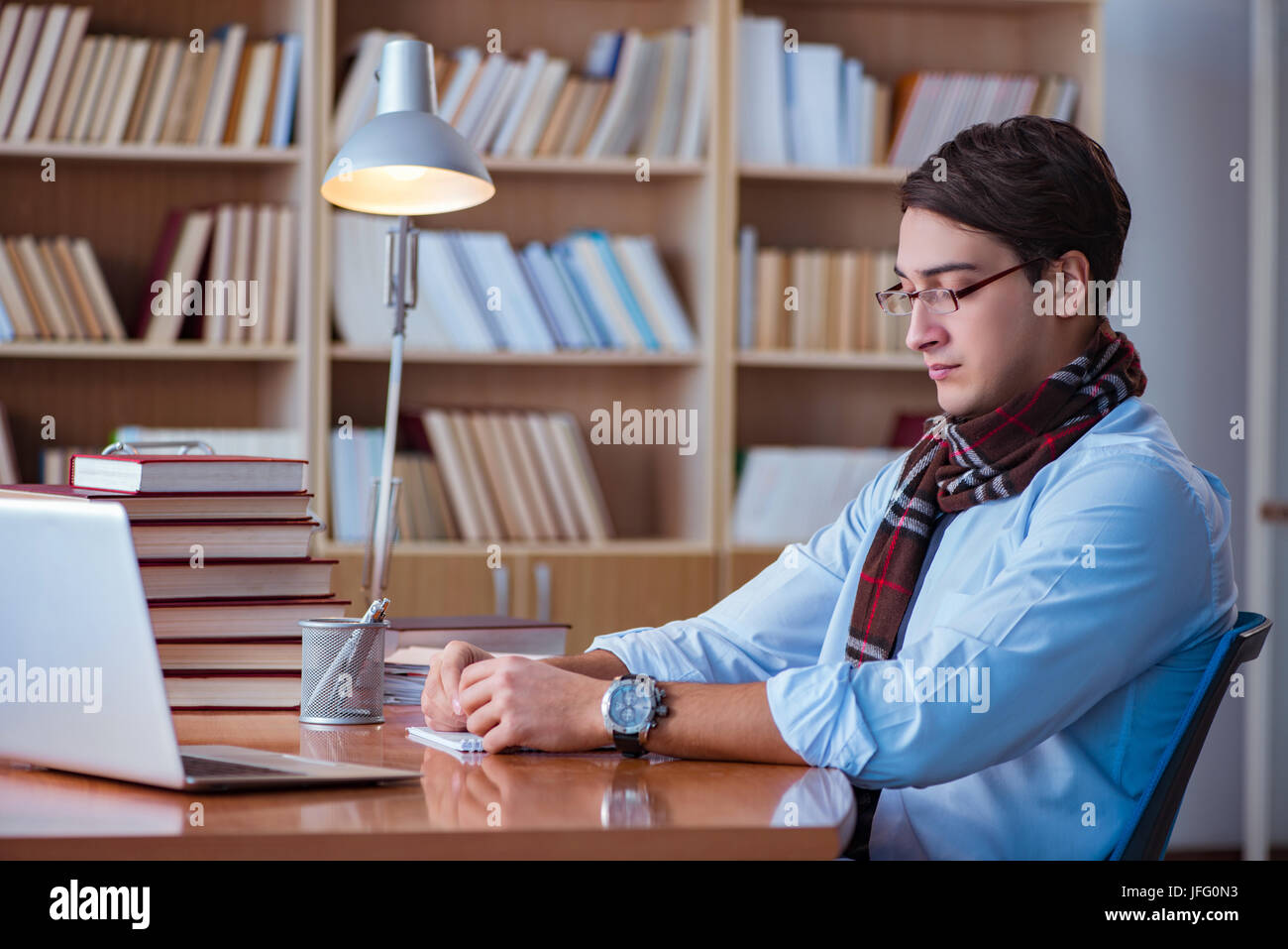 Young book writer writing in library Stock Photo - Alamy