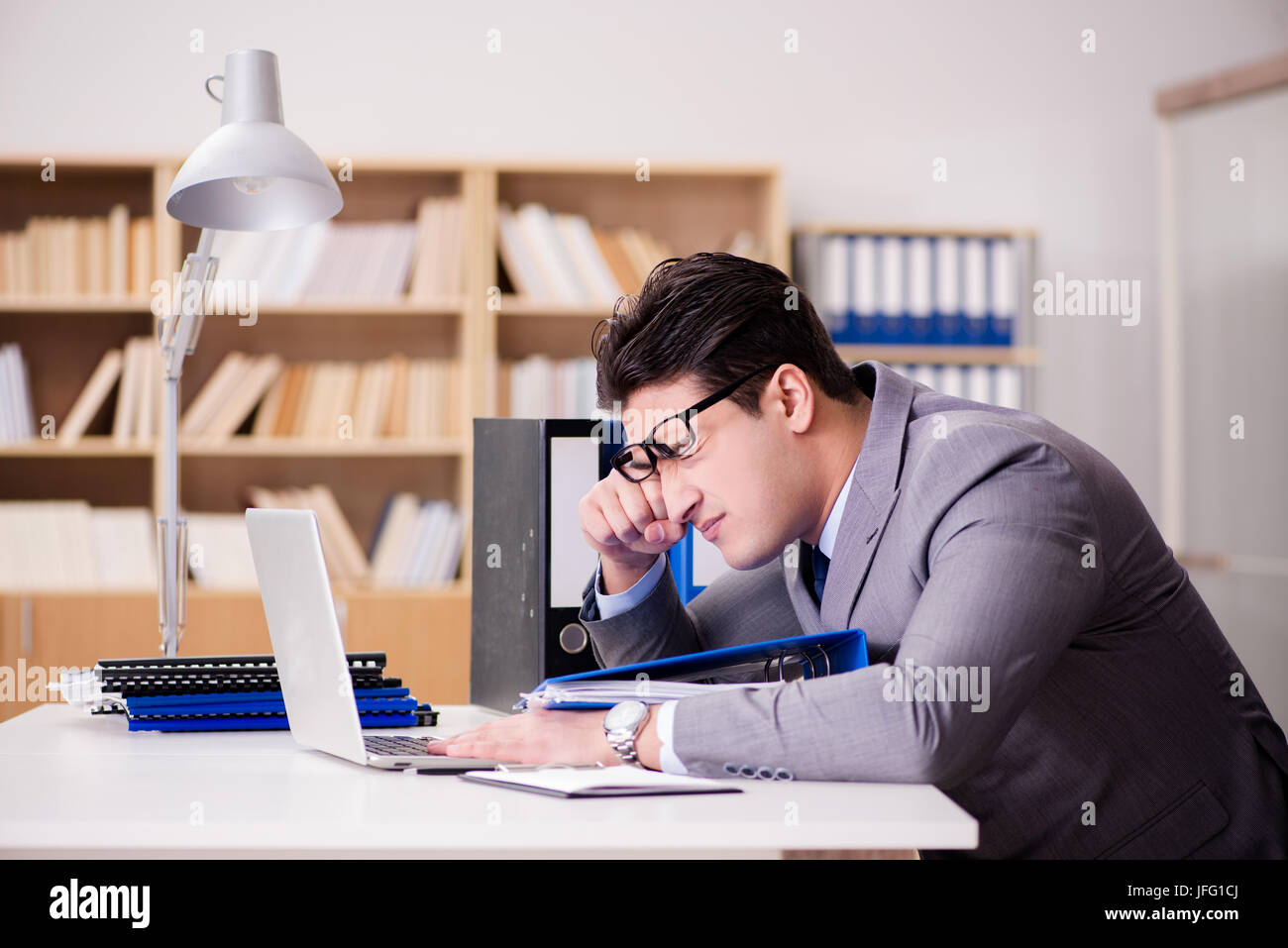 Tired businessman working in the office Stock Photo - Alamy