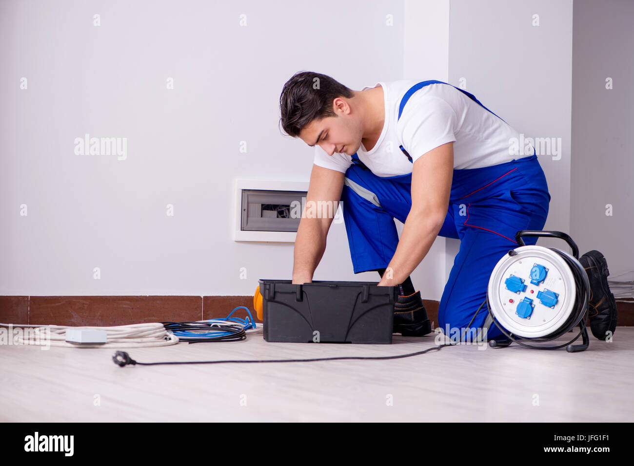 Man doing electrical repairs at home Stock Photo - Alamy