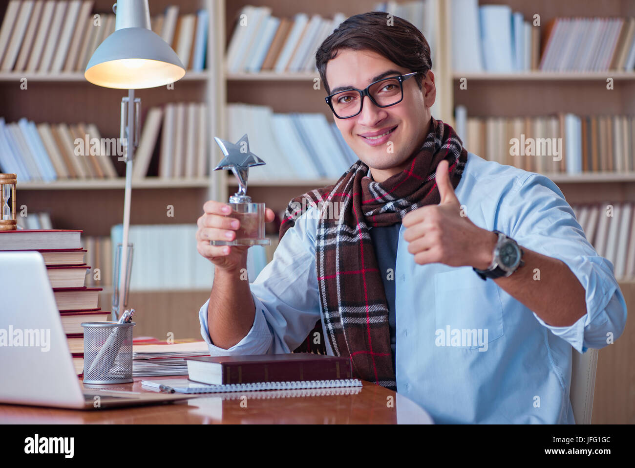 Young book writer writing in library Stock Photo - Alamy