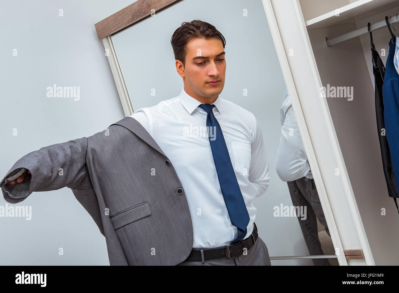 Businessman dressing up for work Stock Photo - Alamy