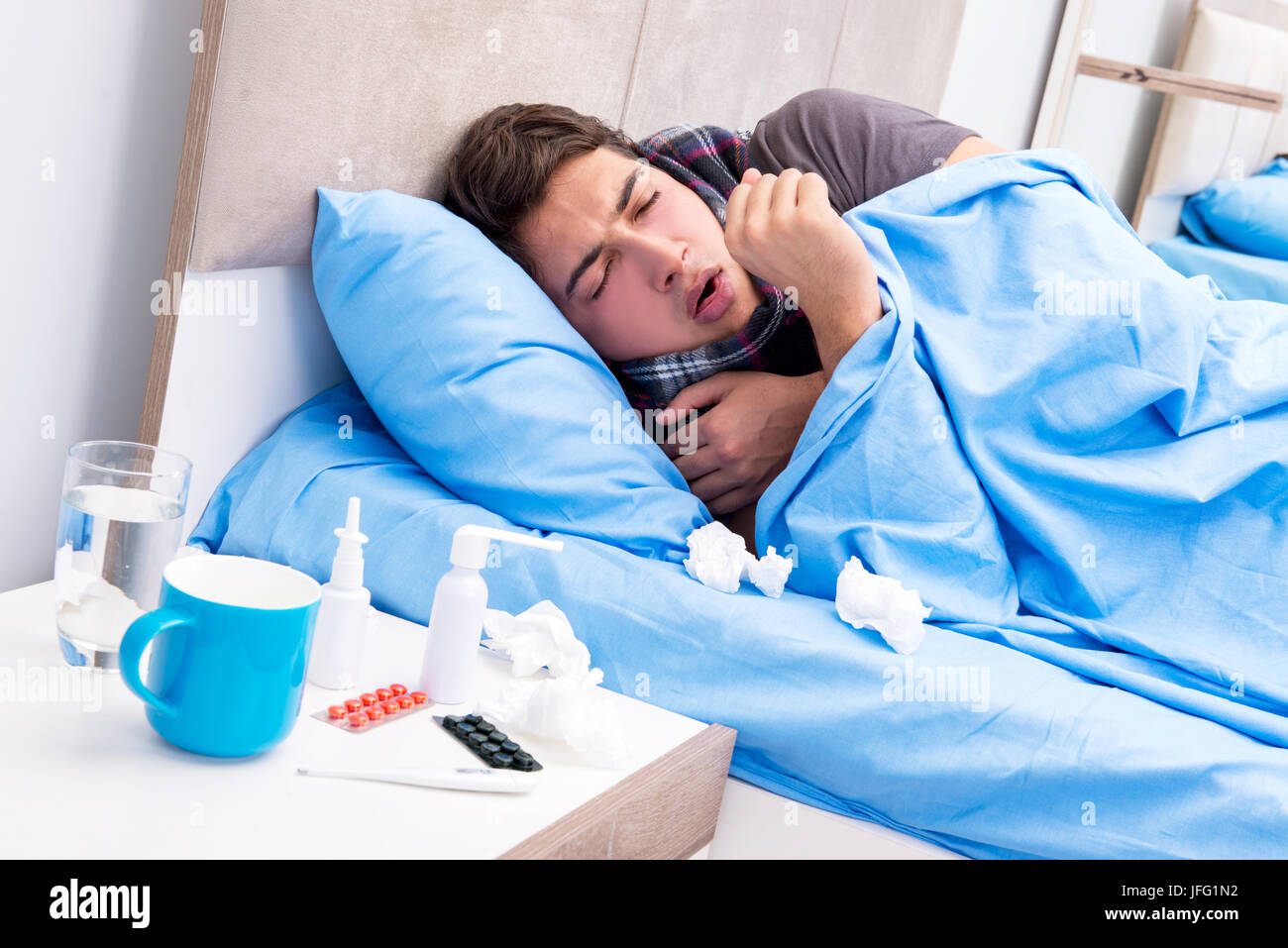 Sick man with flu lying in the bed Stock Photo - Alamy