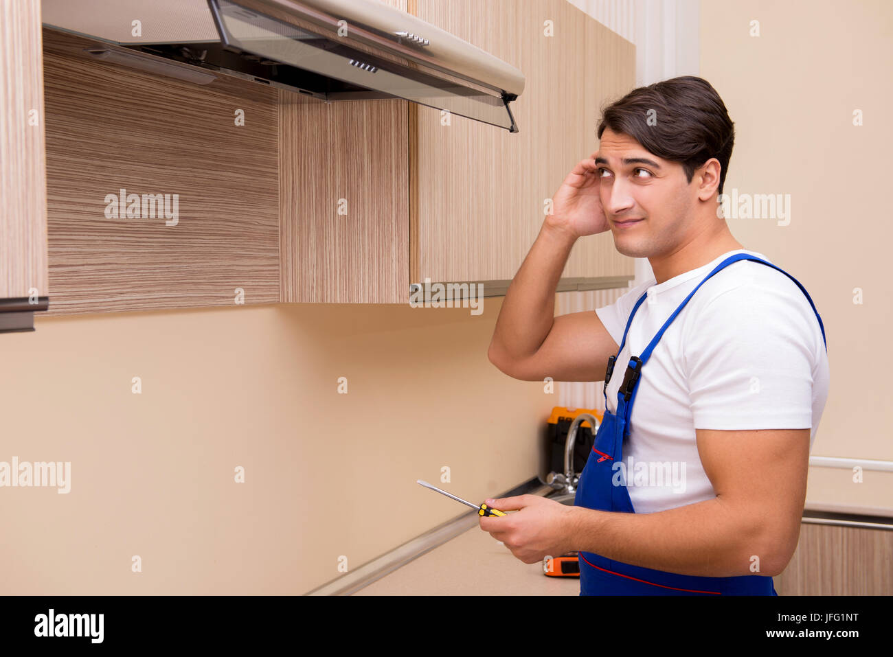 Young man working with kitchen equipment Stock Photo - Alamy