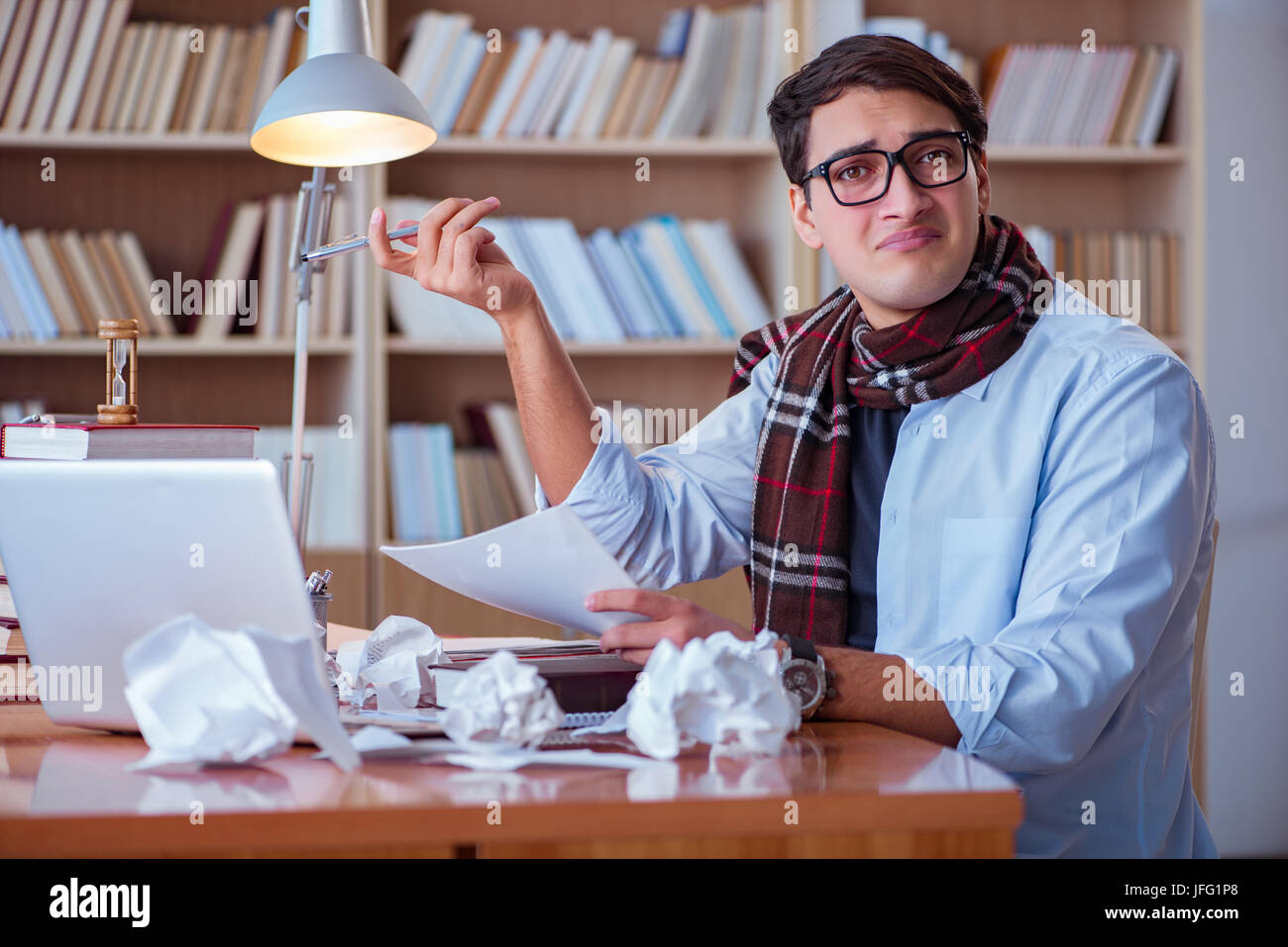 Young book writer writing in library Stock Photo - Alamy