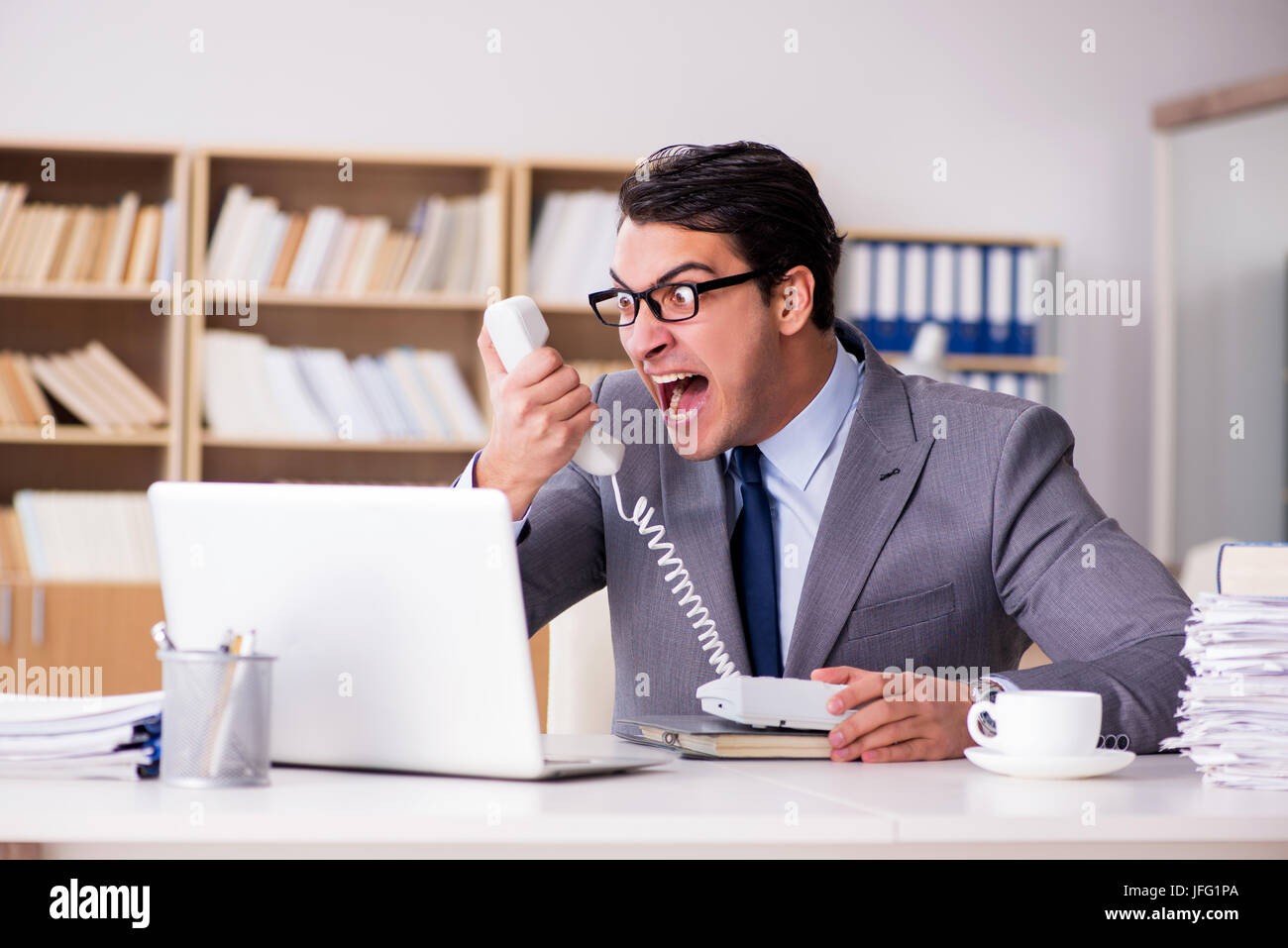 Angry businessman working in the office Stock Photo - Alamy