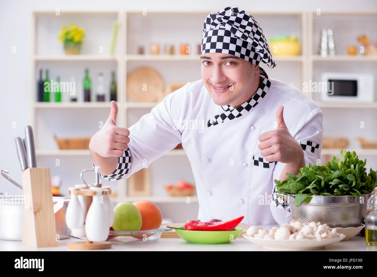 Young male cook working in the kitchen Stock Photo - Alamy