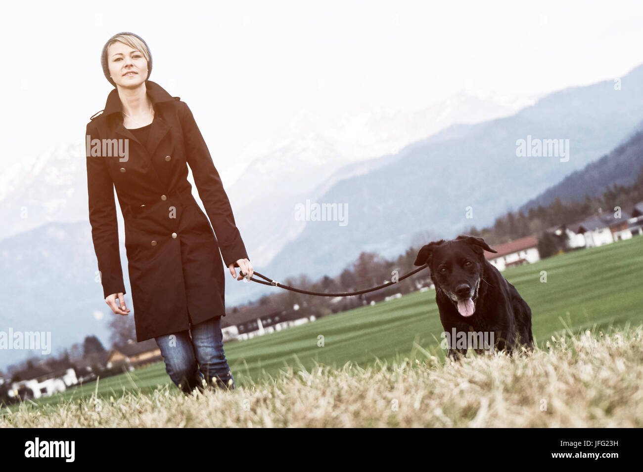 Young female takes her dog out Stock Photo - Alamy