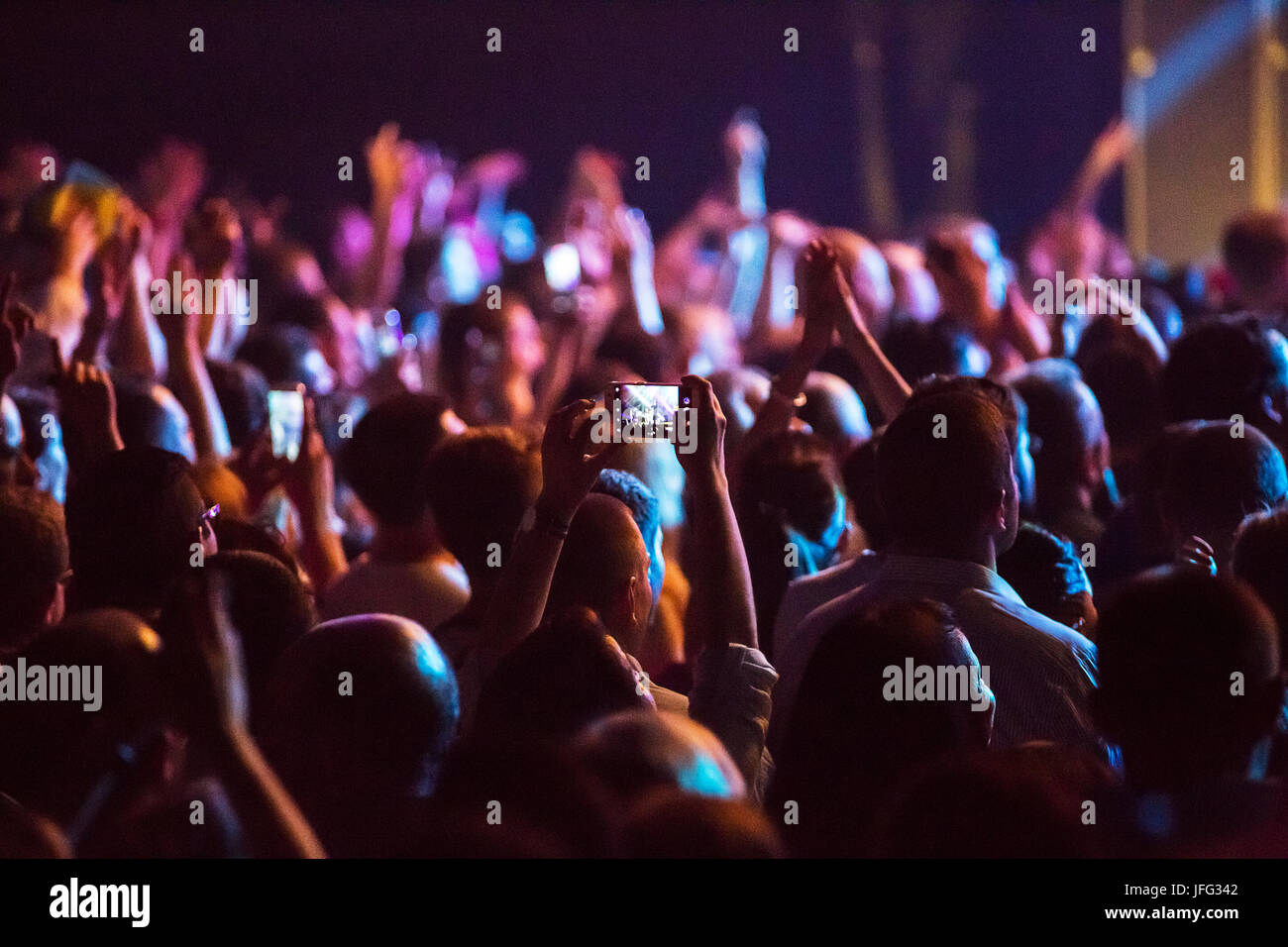 Crowd at concert and blurred stage lights Stock Photo - Alamy