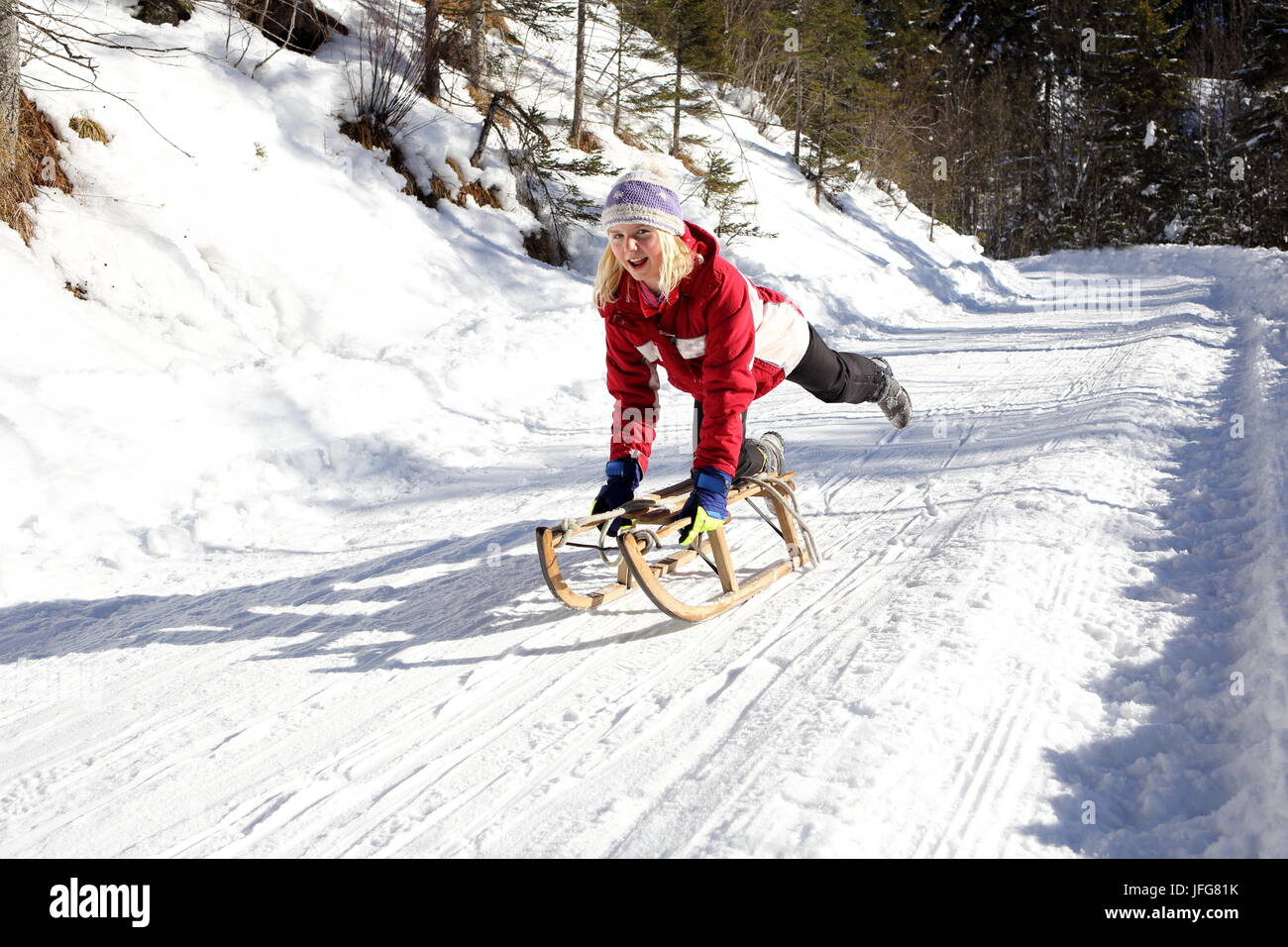 girl has fun with sledge Stock Photo - Alamy