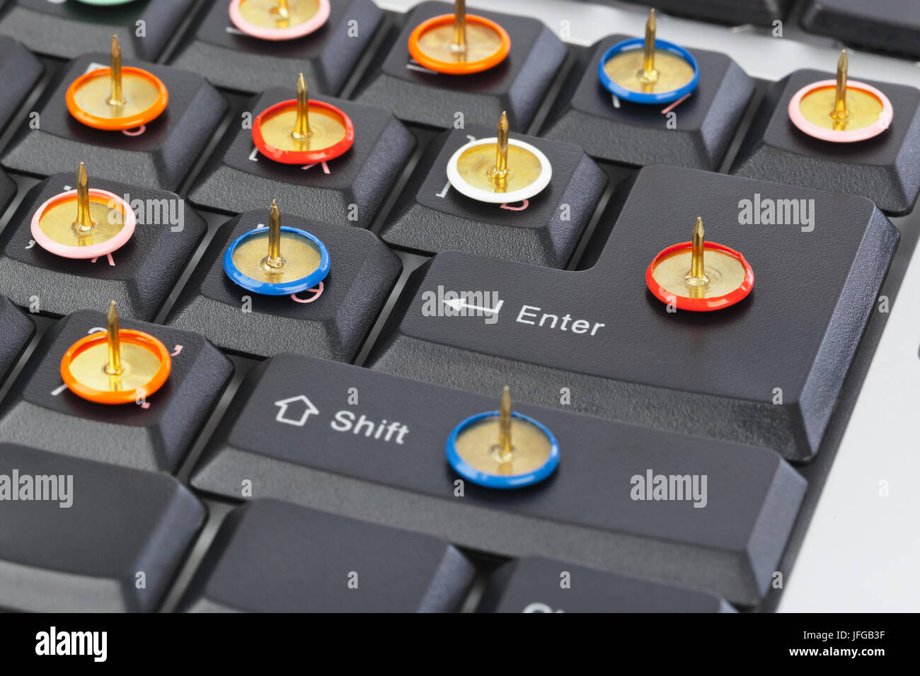 Pins on computer keyboard Stock Photo - Alamy
