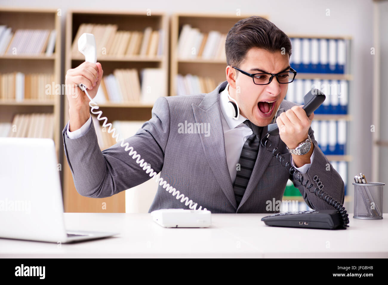 Angry helpdesk operator yelling in office Stock Photo - Alamy