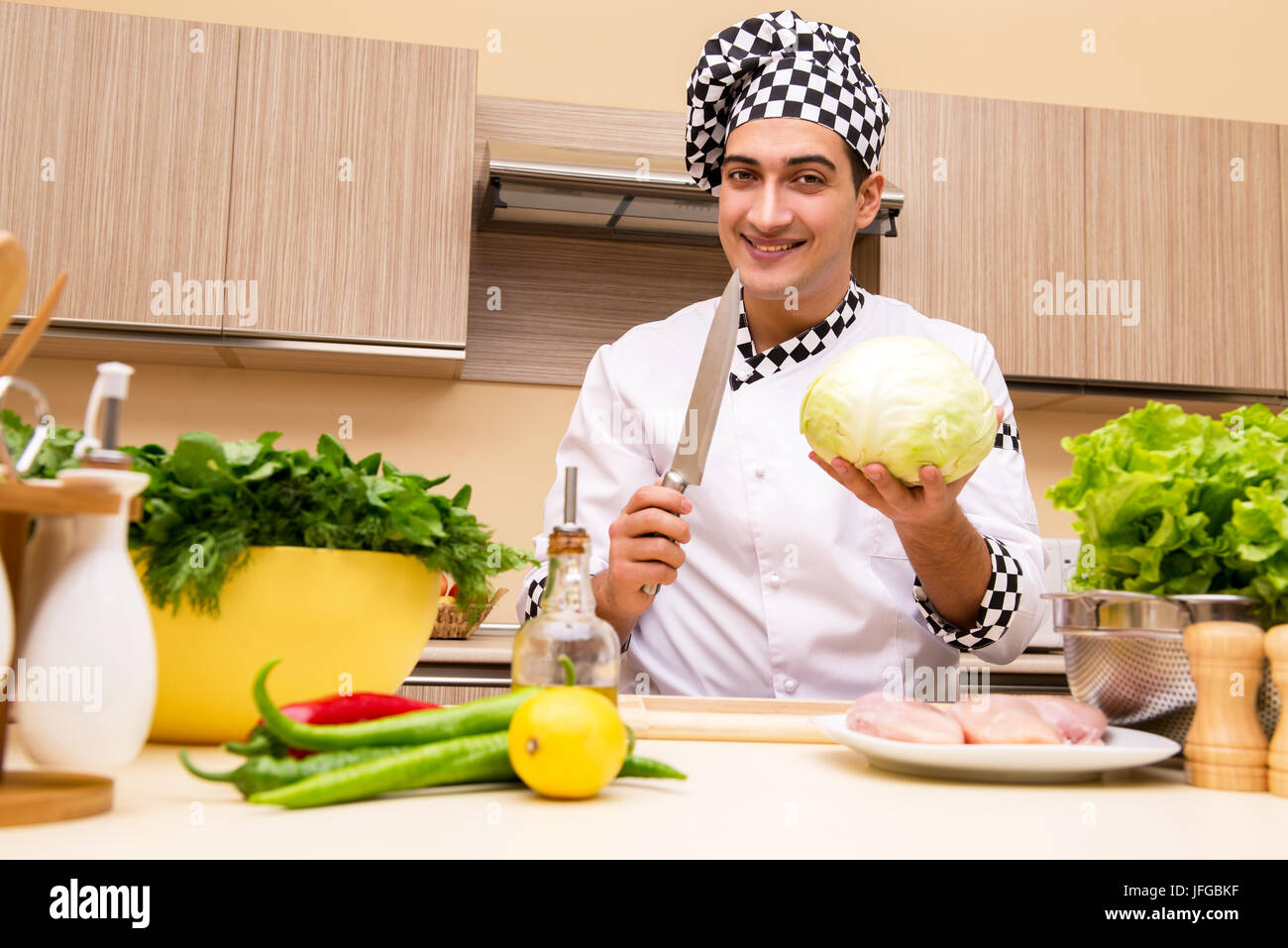 Young chef working in the kitchen Stock Photo - Alamy