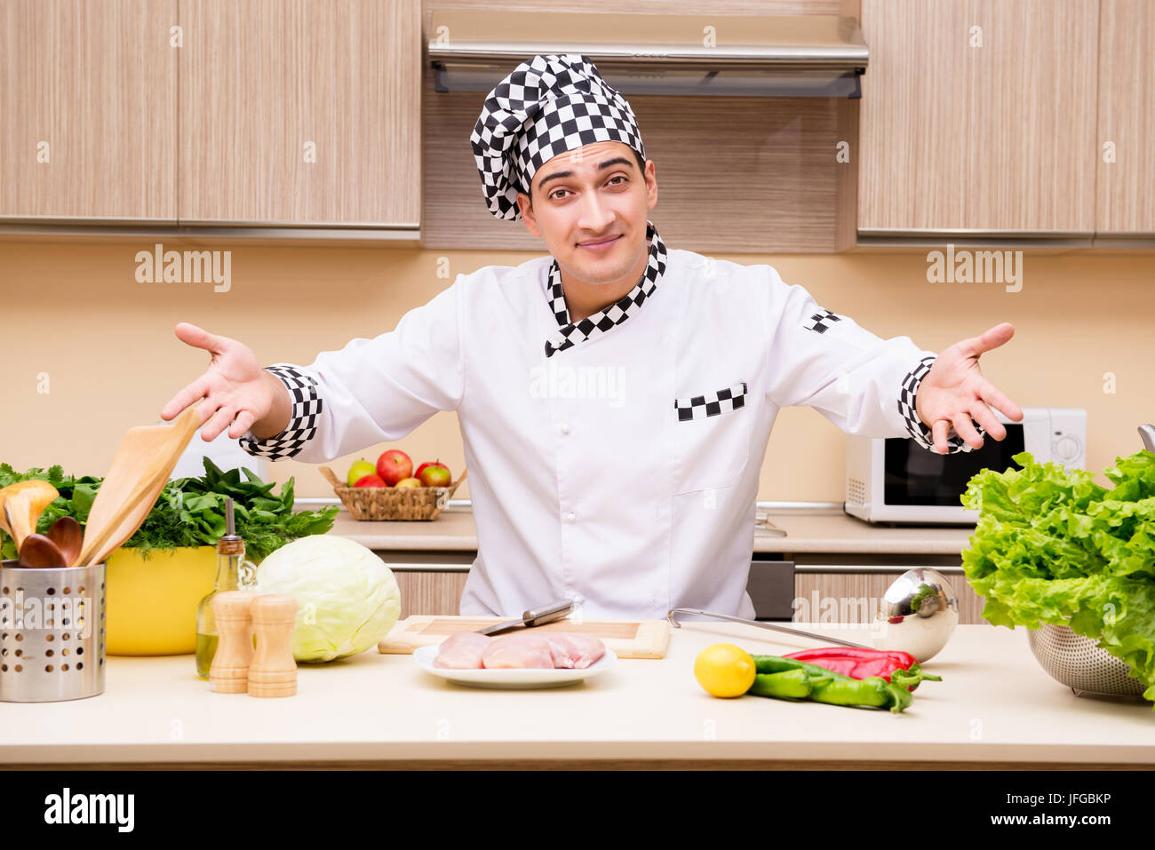 Young chef working in the kitchen Stock Photo - Alamy