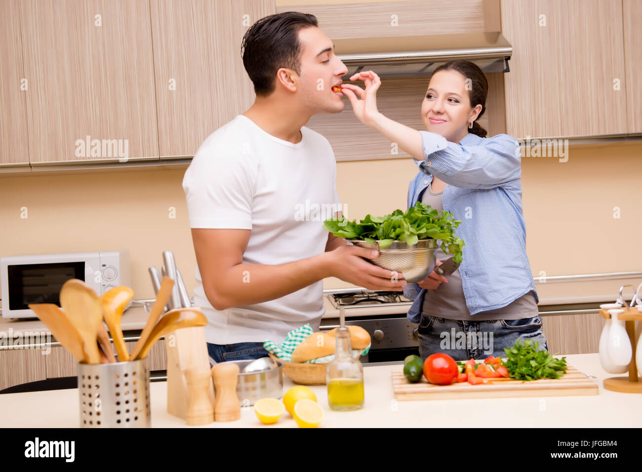 Young family in the kitchen Stock Photo - Alamy