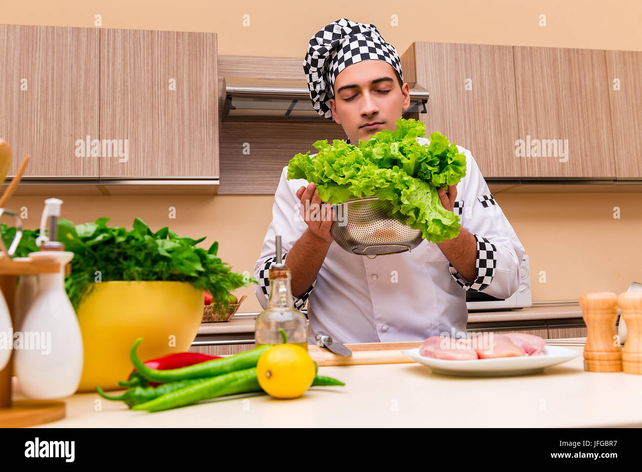 Young chef working in the kitchen Stock Photo - Alamy