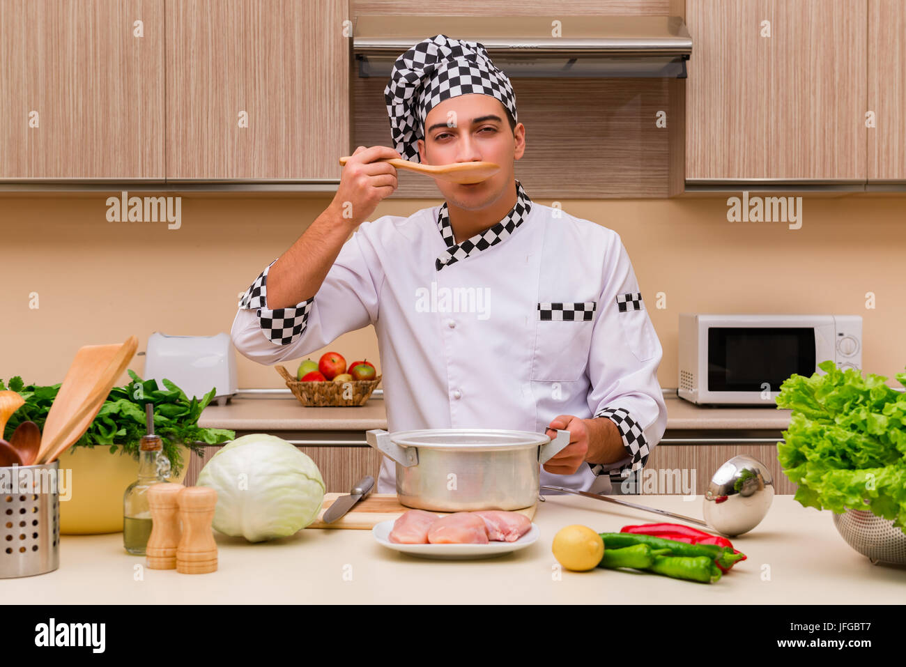 Young chef working in the kitchen Stock Photo - Alamy