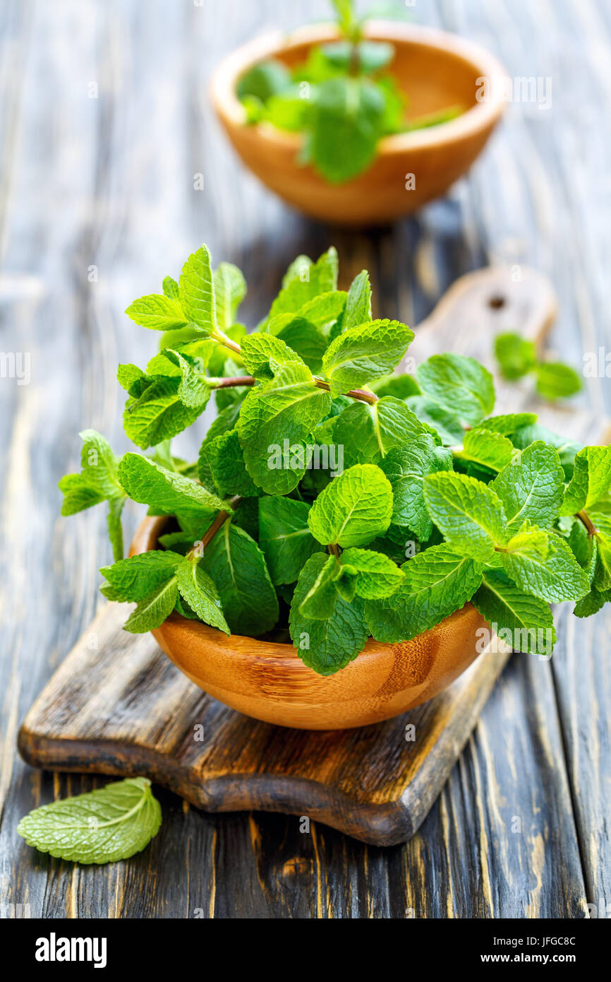 Wooden bowls with fresh mint Stock Photo - Alamy