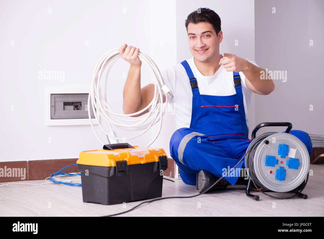 Young electrician working on socket at home Stock Photo - Alamy