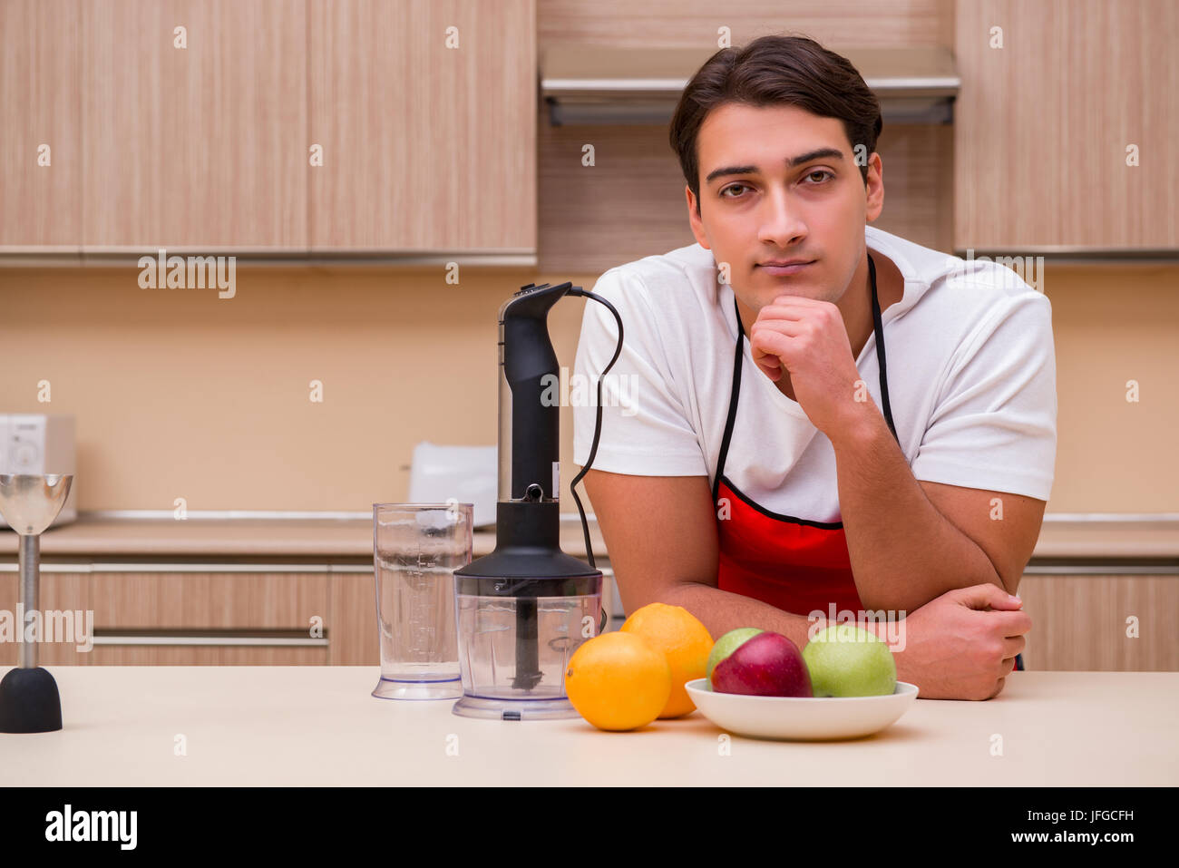 Handsome man working at the kitchen Stock Photo - Alamy