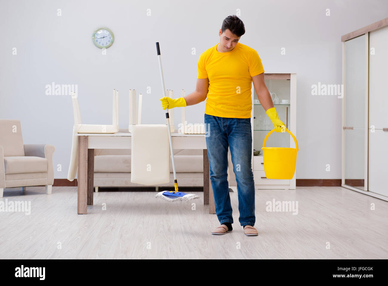 Man cleaning the house helping his wife Stock Photo - Alamy