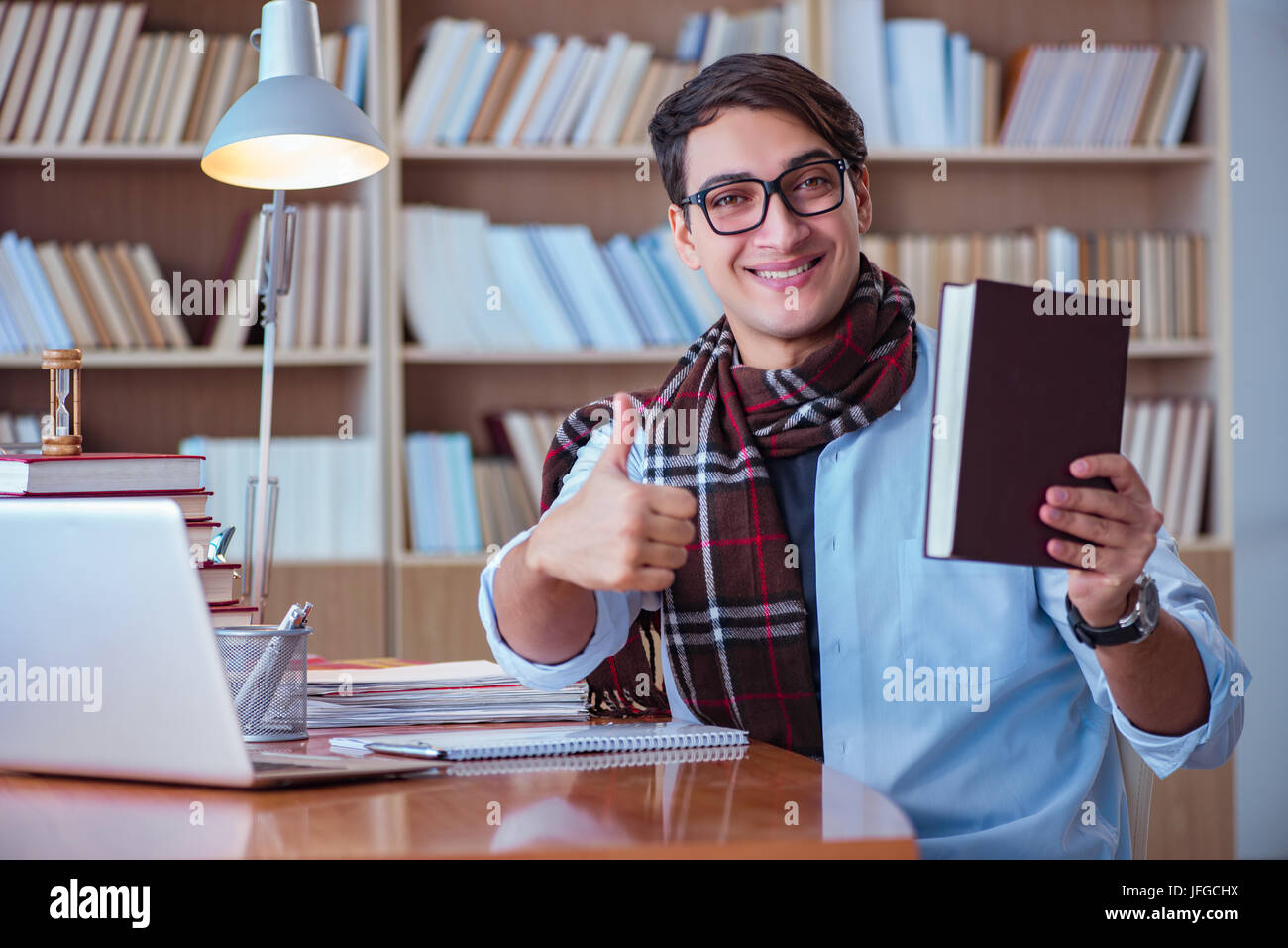 Young book writer writing in library Stock Photo - Alamy