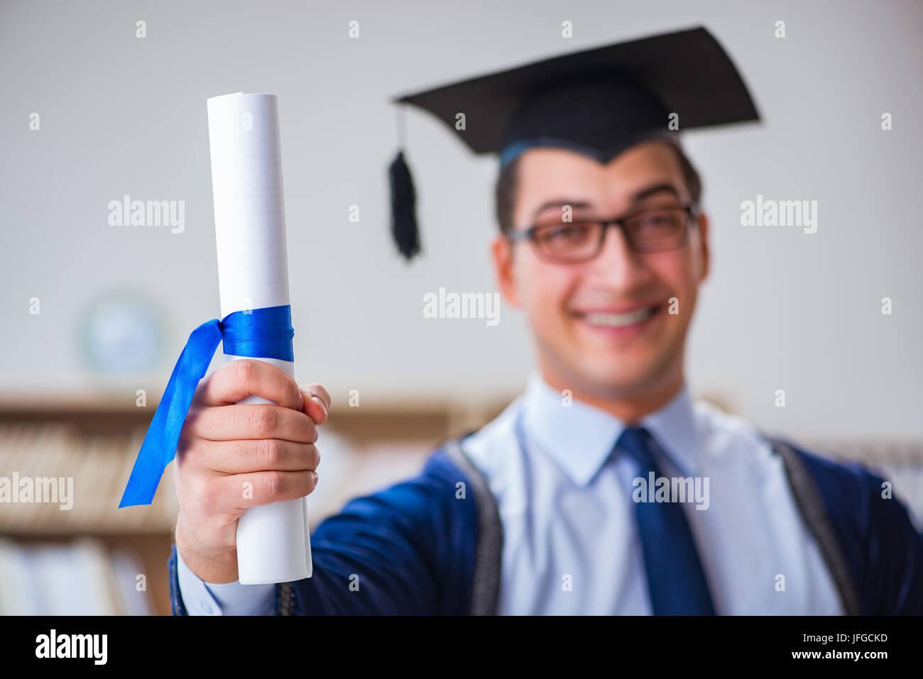 Young man graduating from university Stock Photo - Alamy
