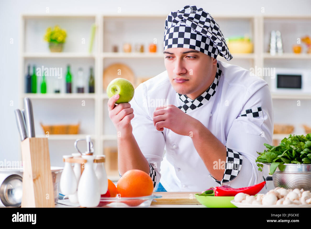 Young male cook working in the kitchen Stock Photo - Alamy