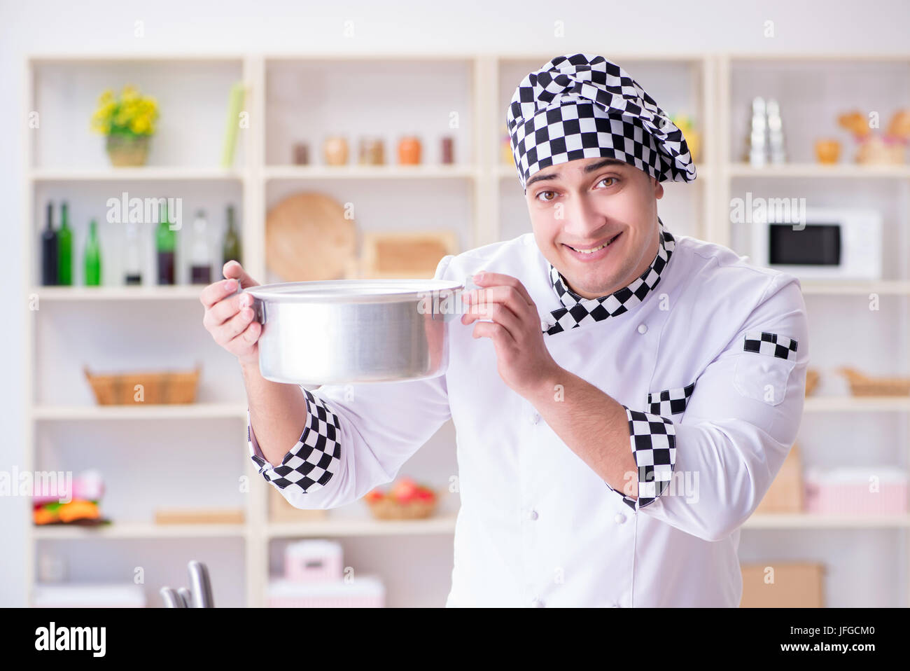 Young male cook working in the kitchen Stock Photo - Alamy