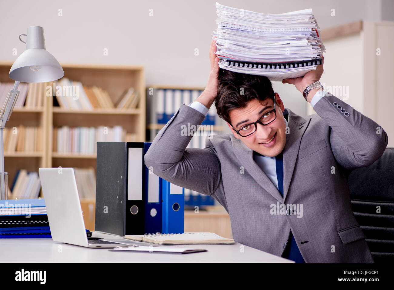 Businessman with too much paperwork Stock Photo - Alamy