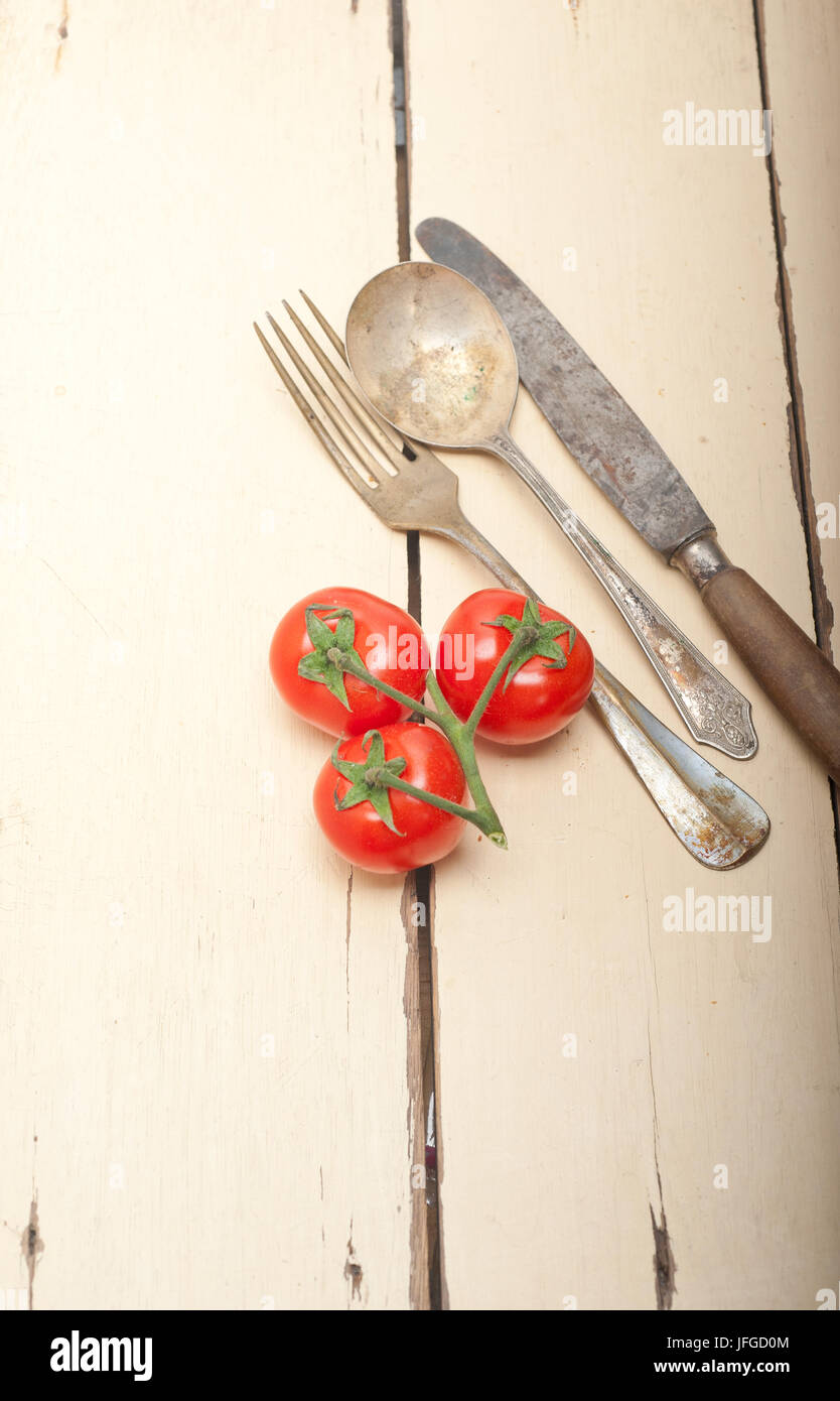 ripe cherry tomatoes over white wood Stock Photo - Alamy