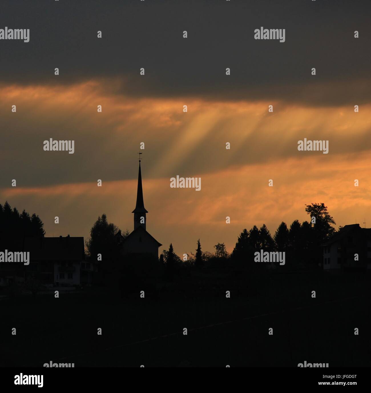 Sunbeams over a church Stock Photo - Alamy