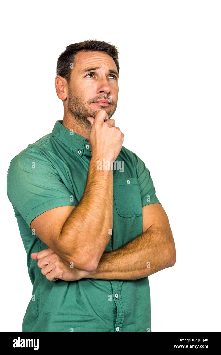 Thoughtful man with hand on chin looking away Stock Photo - Alamy