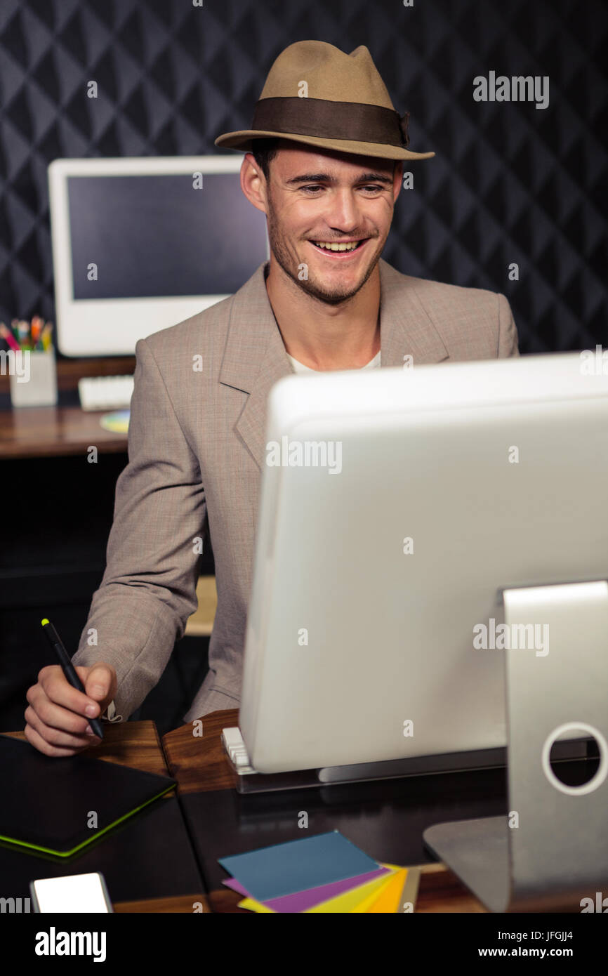 Creative businessman using computer and graphic tablet Stock Photo - Alamy