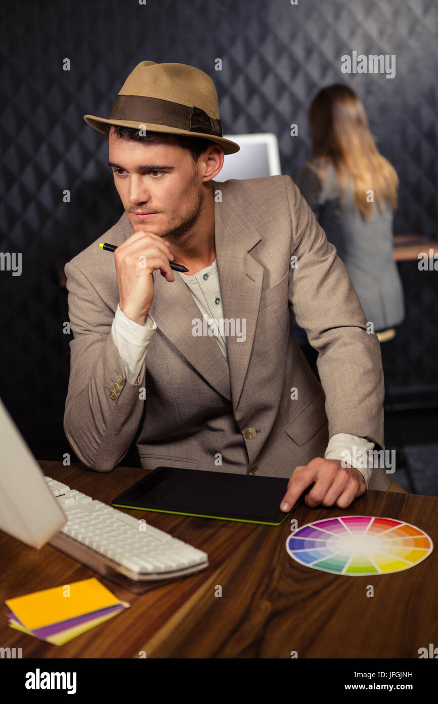 Creative businessman using computer and graphic tablet Stock Photo - Alamy