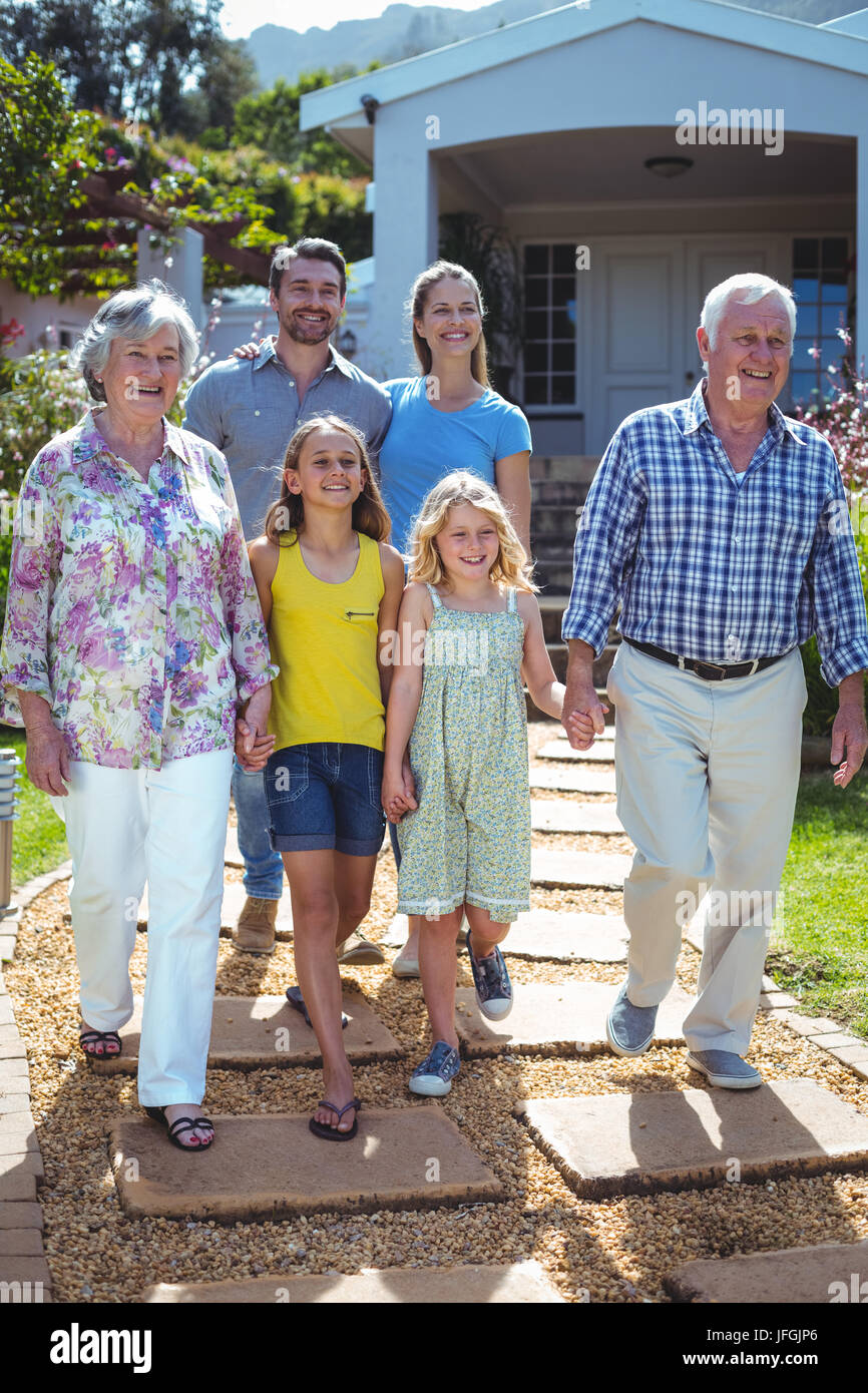 Happy multi-generation family walking on footpath Stock Photo - Alamy
