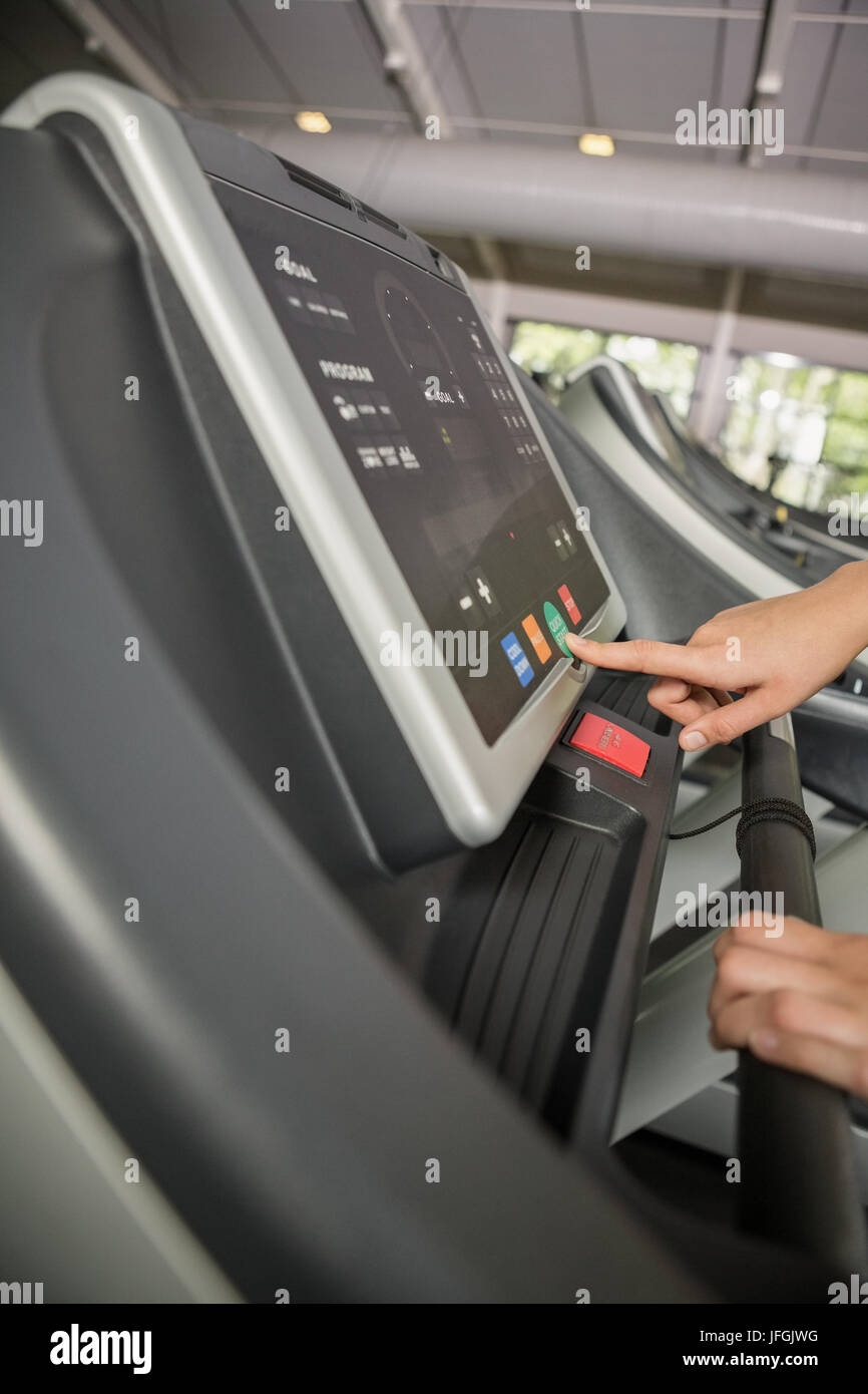 Hand of a person setting control panel of treadmill Stock Photo - Alamy