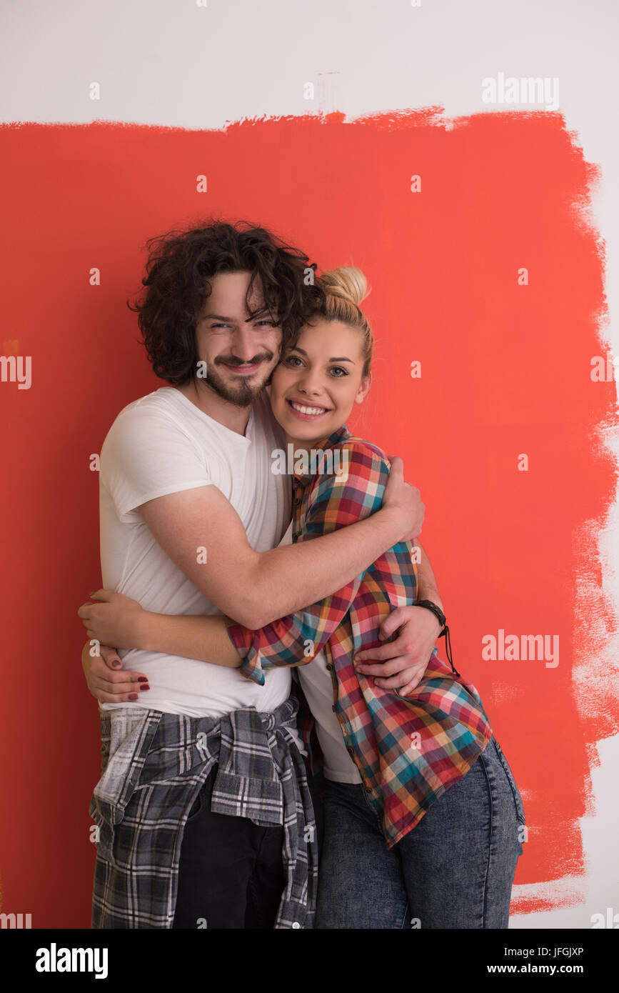 Portrait of a happy young smiling couple in love over color background ...