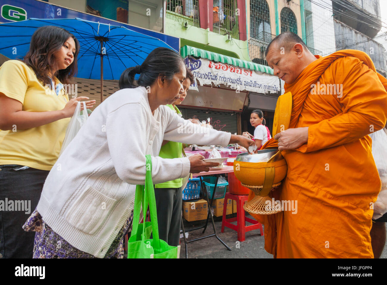 Thailand, Bangkok, Women Giving Food to Monk Stock Photo - Alamy