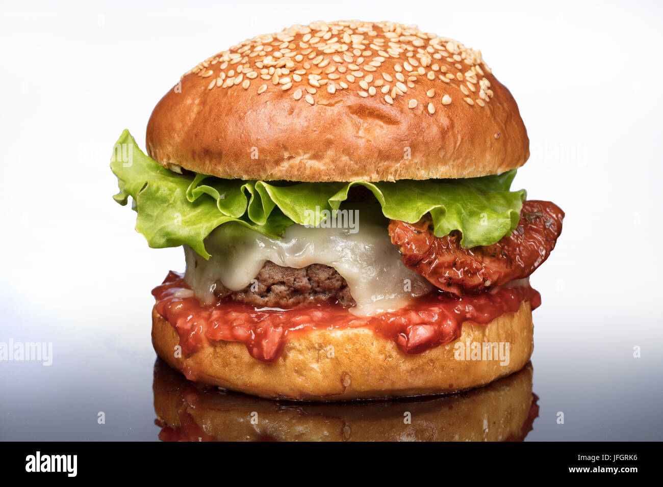 Burger with beef and vegetables on a reflecting glass background Stock ...