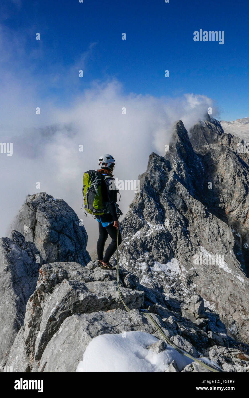 Mountaineer at the Schüsselkarspitze west ridge, view at ...