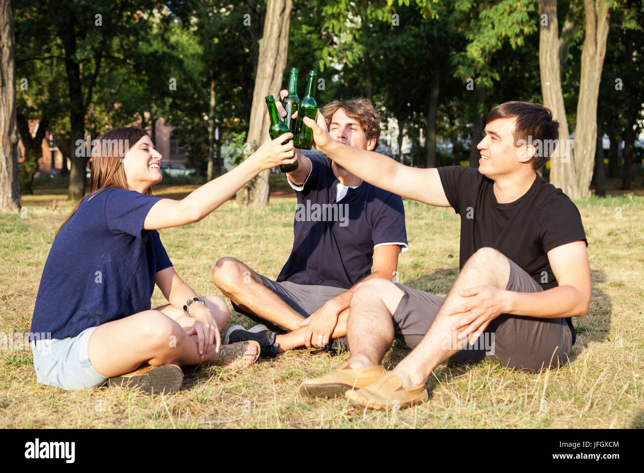 Friends kick off with beer Stock Photo - Alamy
