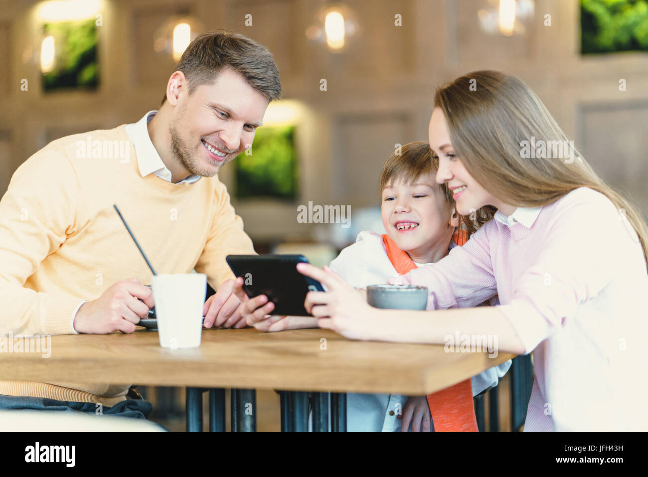 Family in cafe Stock Photo - Alamy