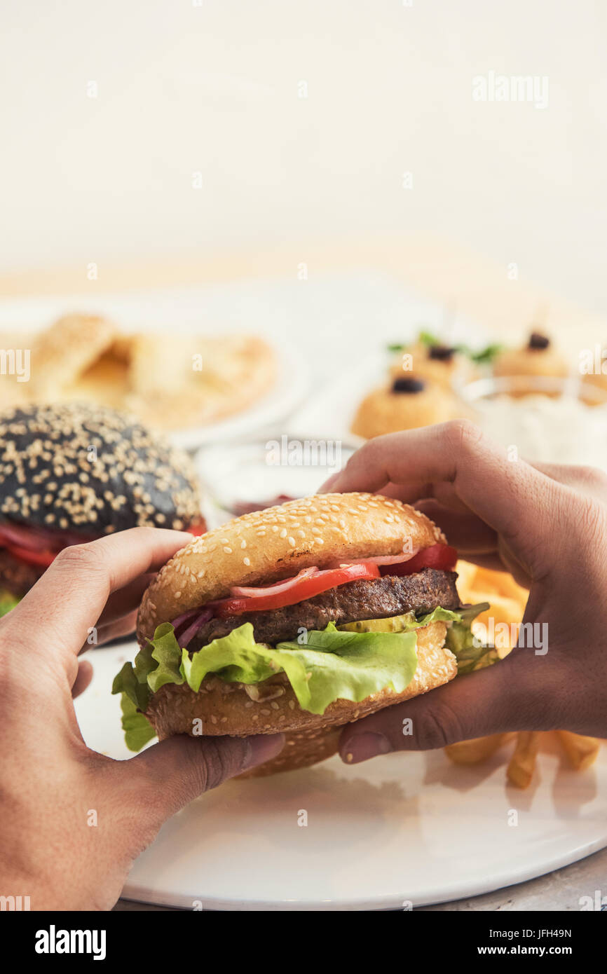 Man eating burgers Stock Photo - Alamy