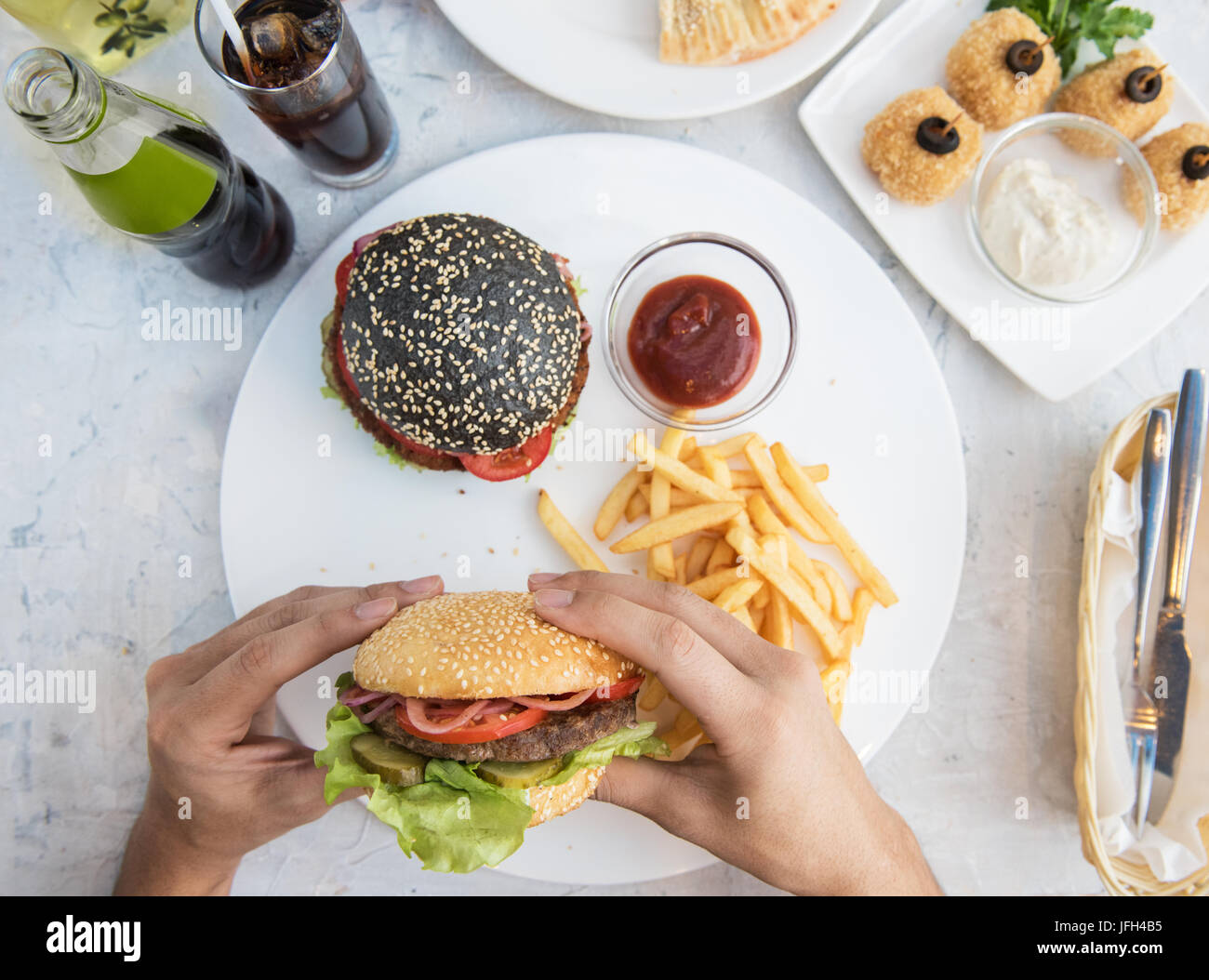 Man eating burgers Stock Photo - Alamy